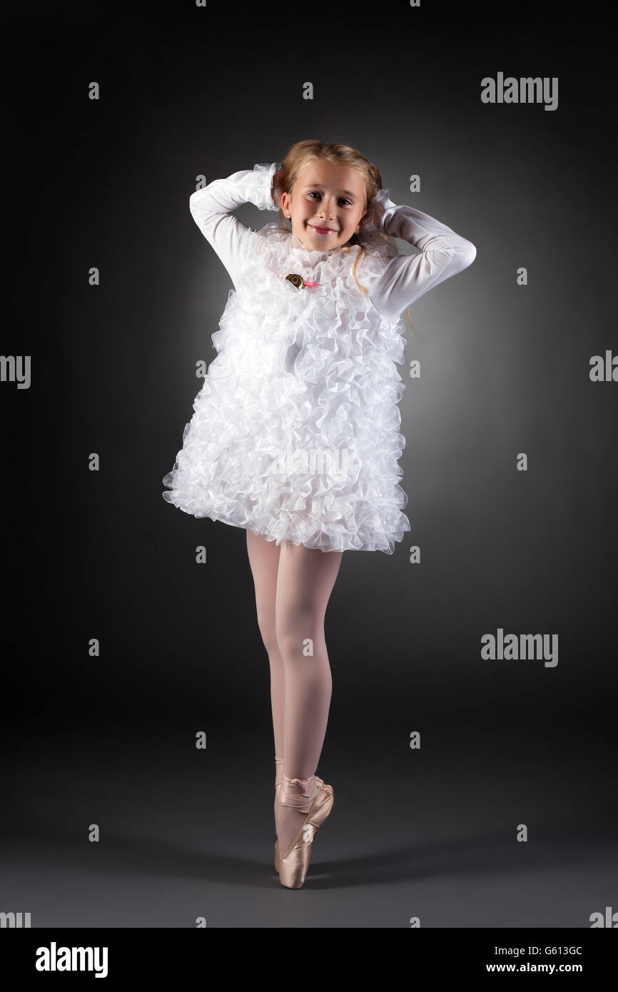 Little ballet dancer posing in white dress Stock Photo - Alamy