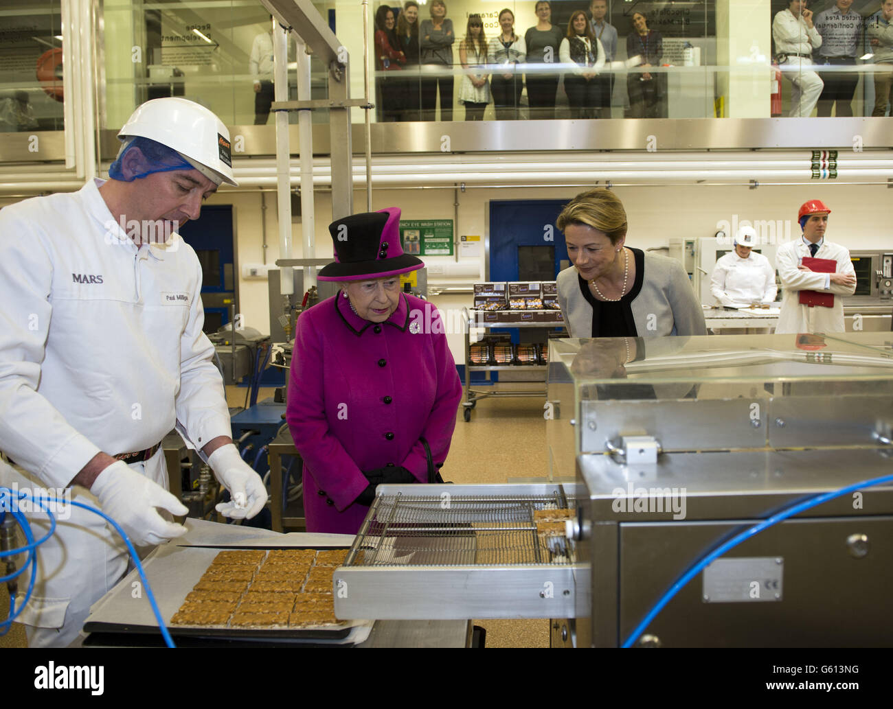 Queen Elizabeth II stands alongside Fiona Dawson President of Mars ...