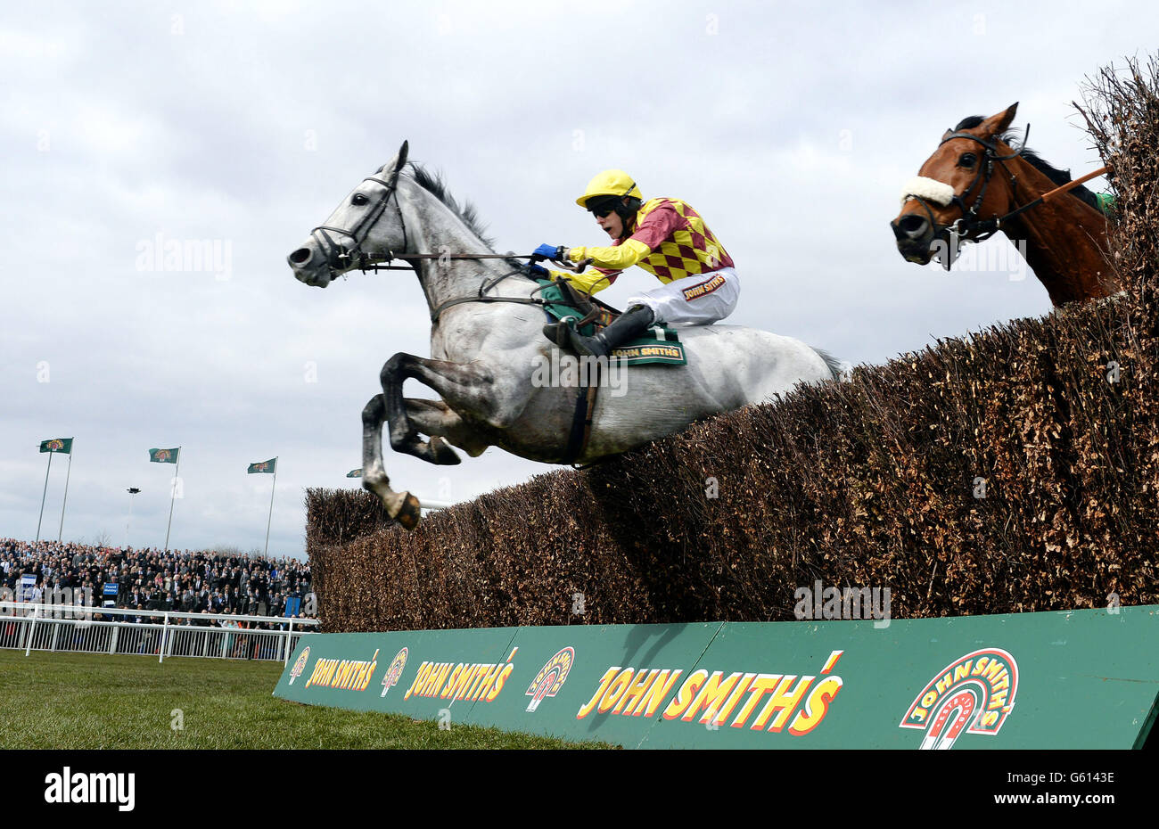 Dynaste and Tom Scudamore (left) jump the final fence on their way to ...