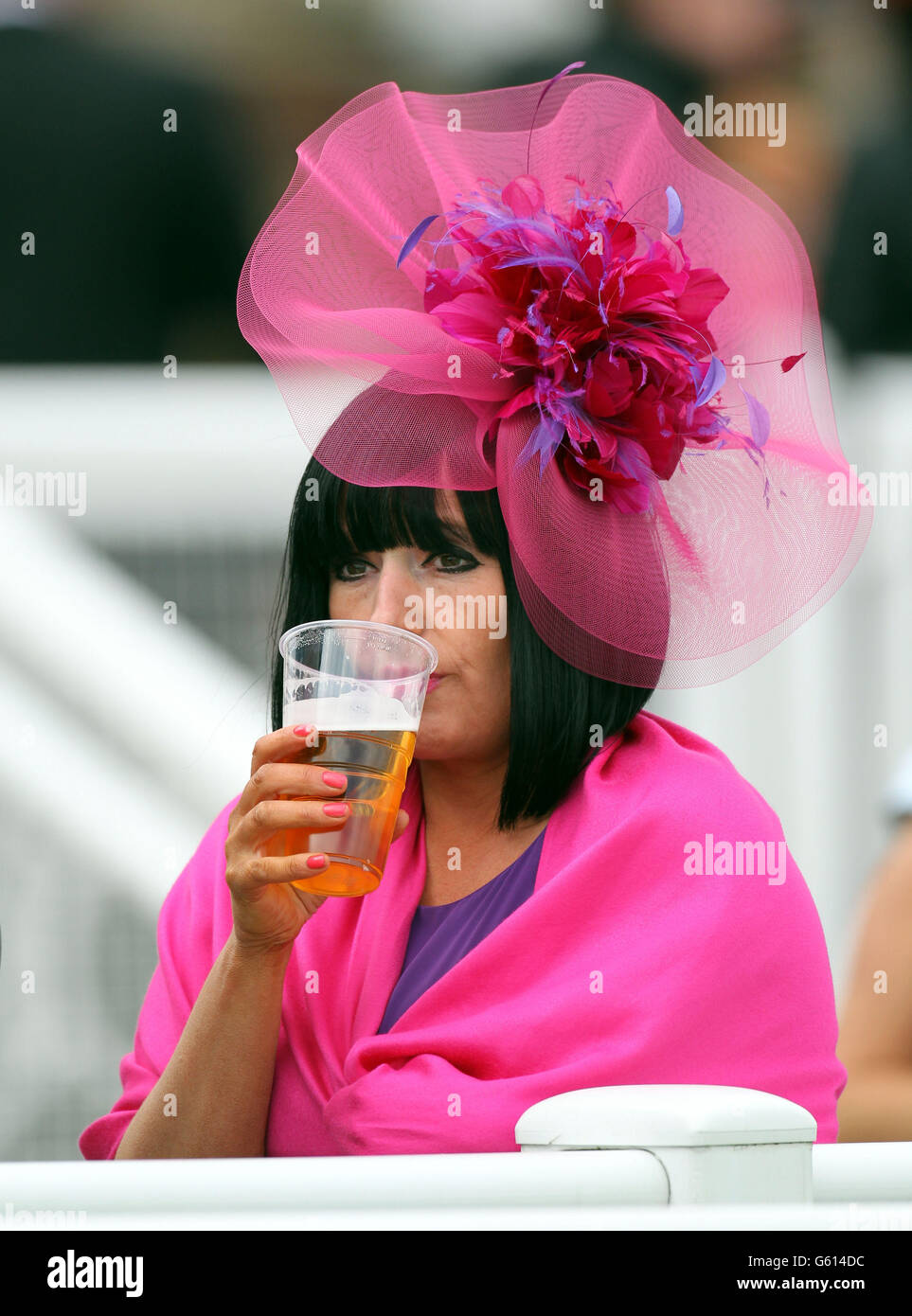 A lady enjoys a pint during Ladies Day at the 2013 John Smith's Grand ...