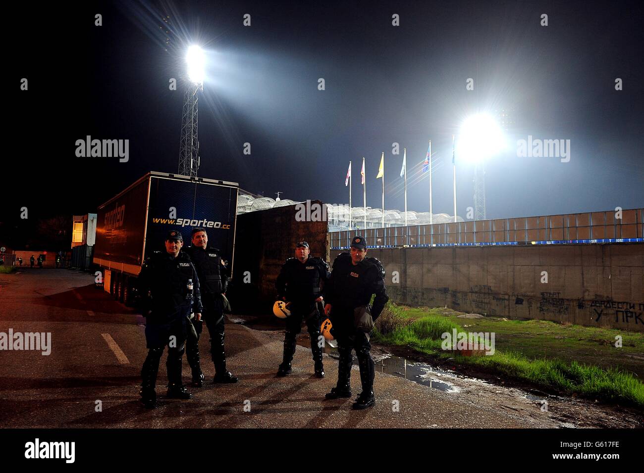 Riot police wait outside the City Stadium before kick-off Stock Photo ...