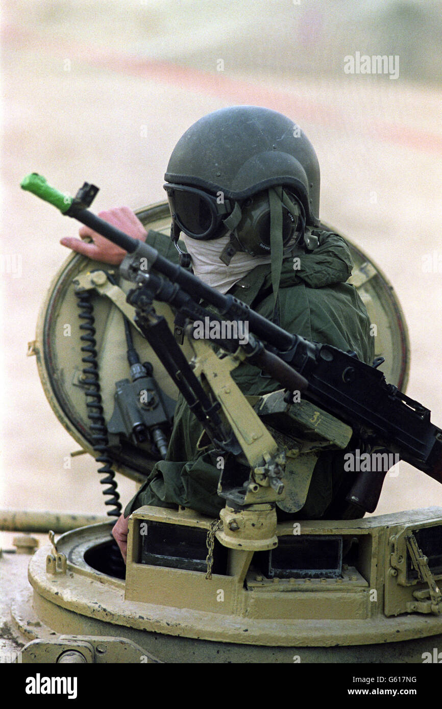 A British Army Desert Rat in the turret of a tank wearing mask and ...