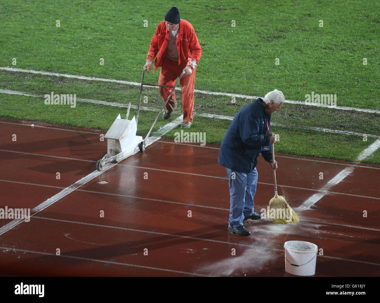 White lines are put down as other lines are scrubbed out at the stadium ...