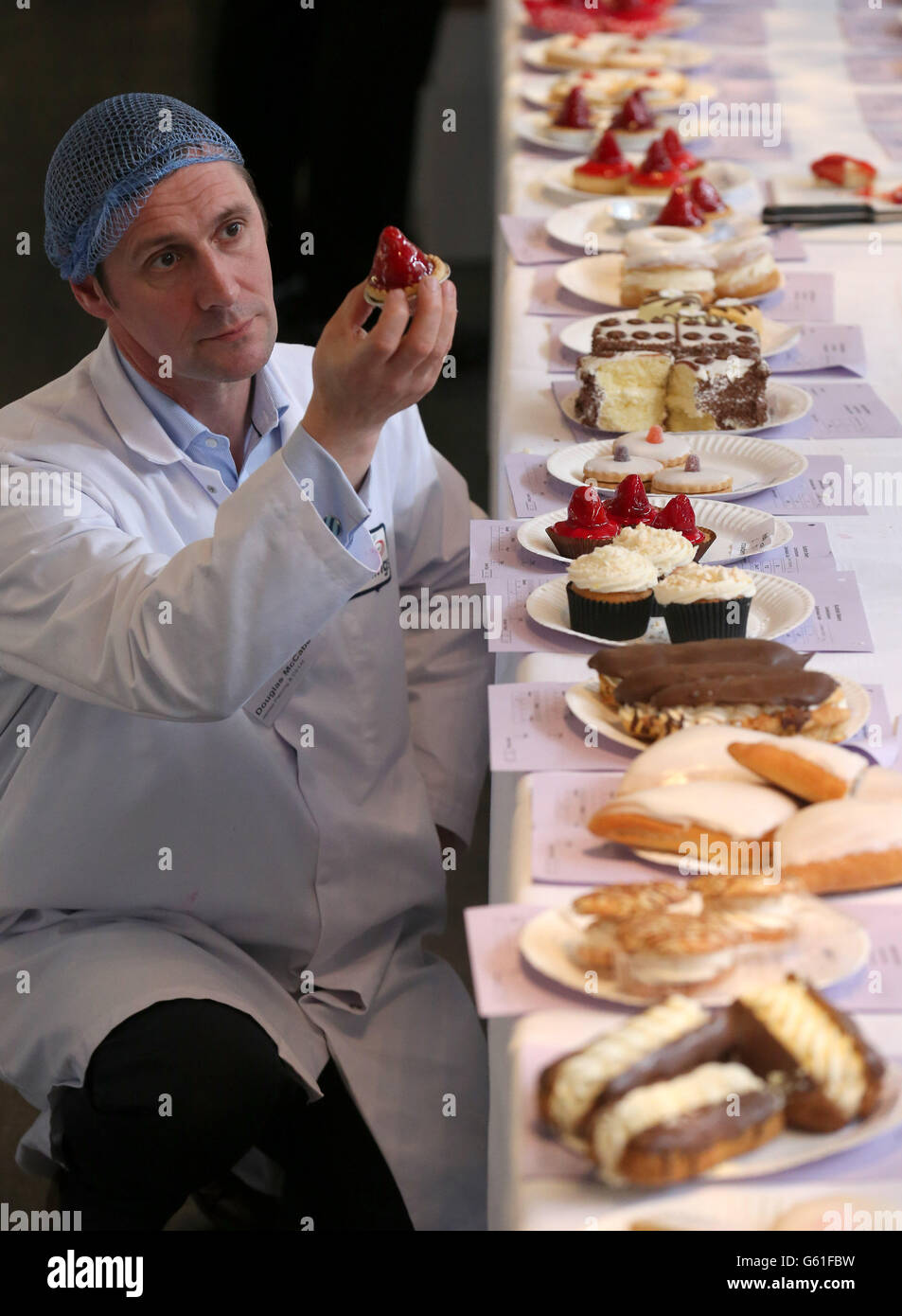 Judge Douglas McCabe inspects a Strawberry tart during judging for the ...