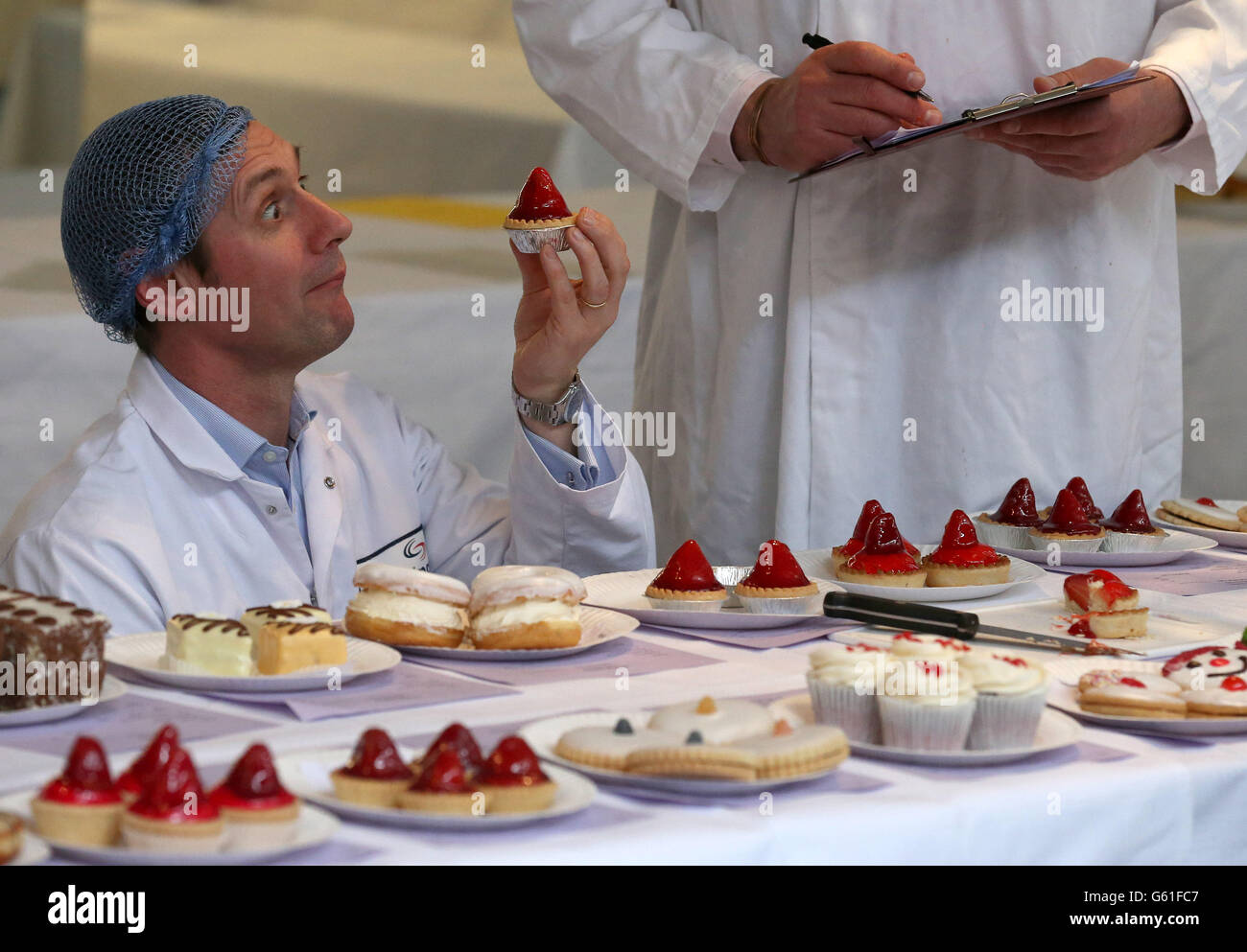 Judge Douglas McCabe inspects a Strawberry tart during judging for the ...