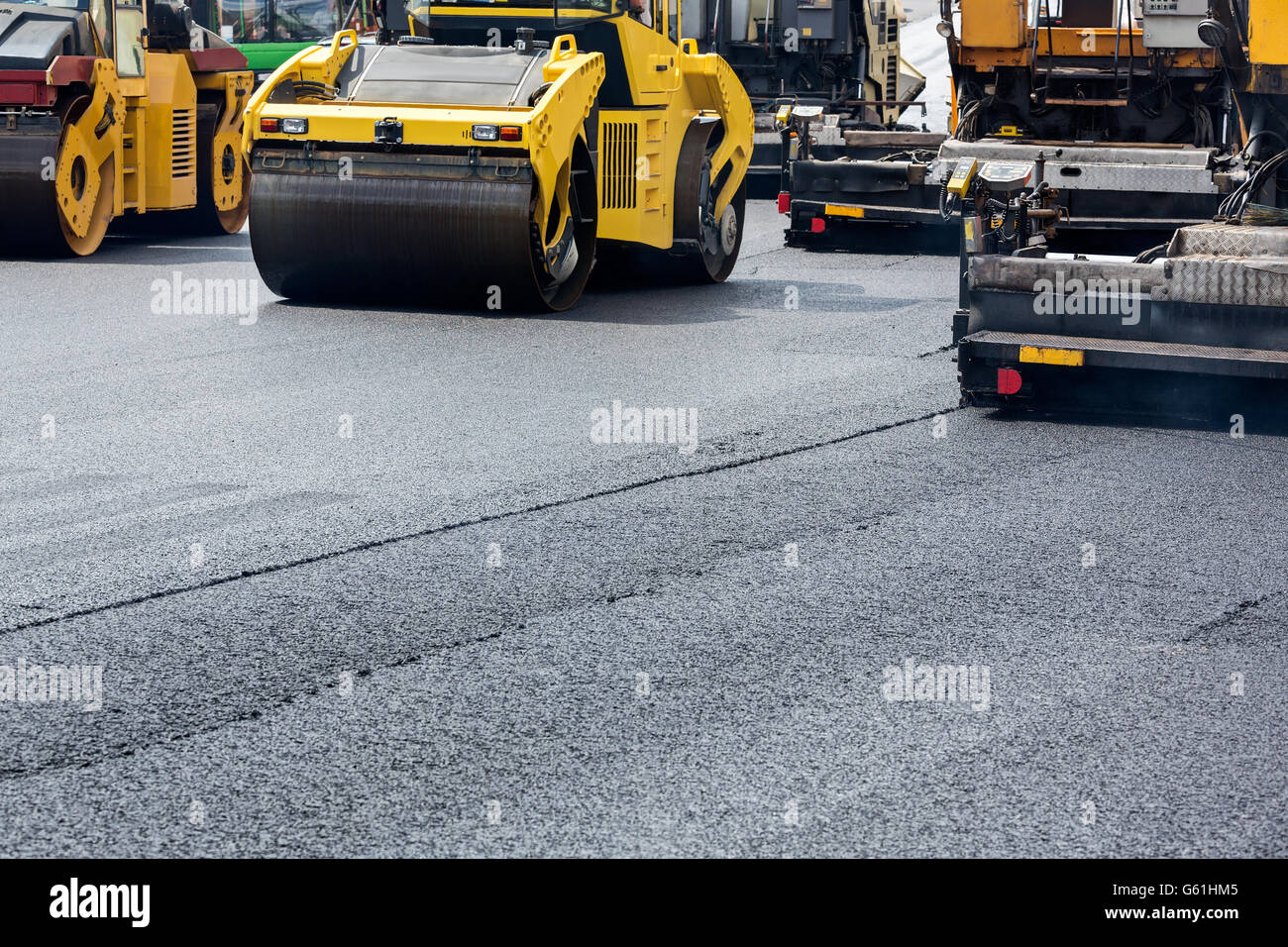 Heavy vibration road roller compactors at asphalt pavement works Stock ...