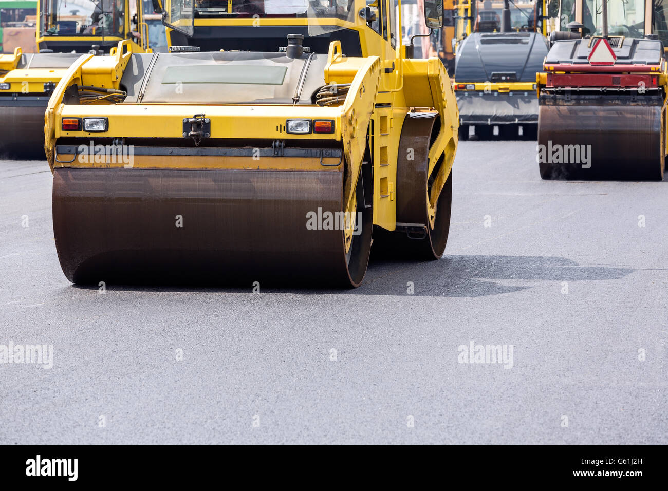 Industrial pavement machines during road construction works Stock Photo ...
