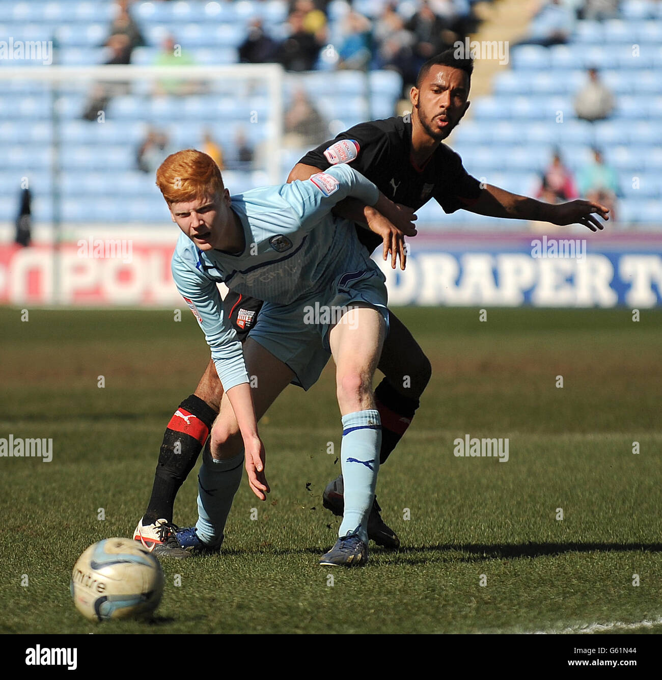 Brentford's Shaleum Logan (back) challenges Ryan Haynes (front) for the ...