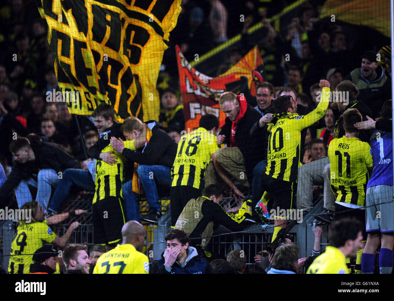 Borussia Dortmund's players climb into the crowd to celebrate after the ...