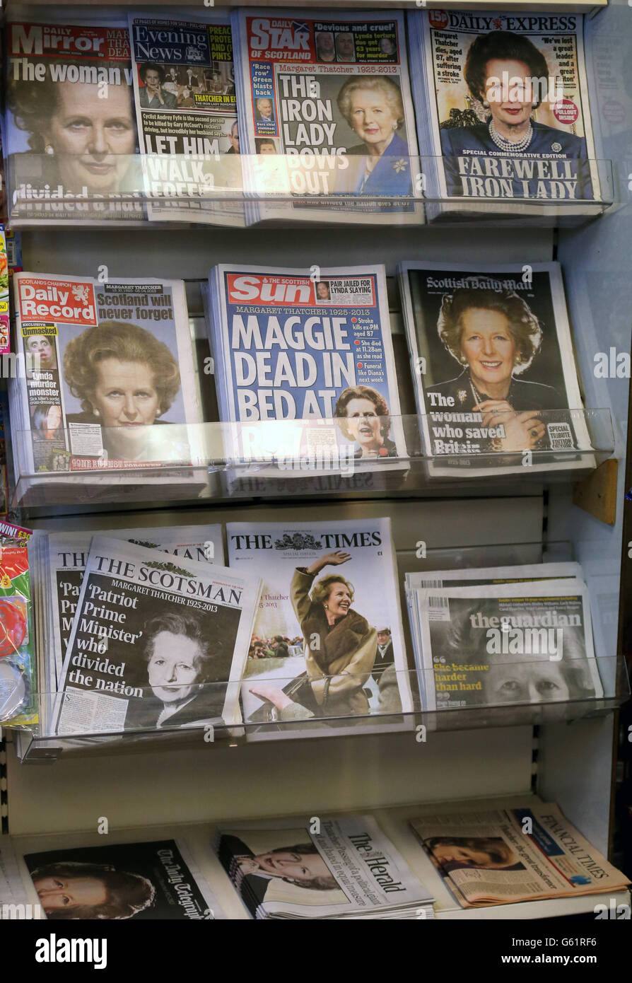 A newspaper stand full of newspapers showing how they reported the ...