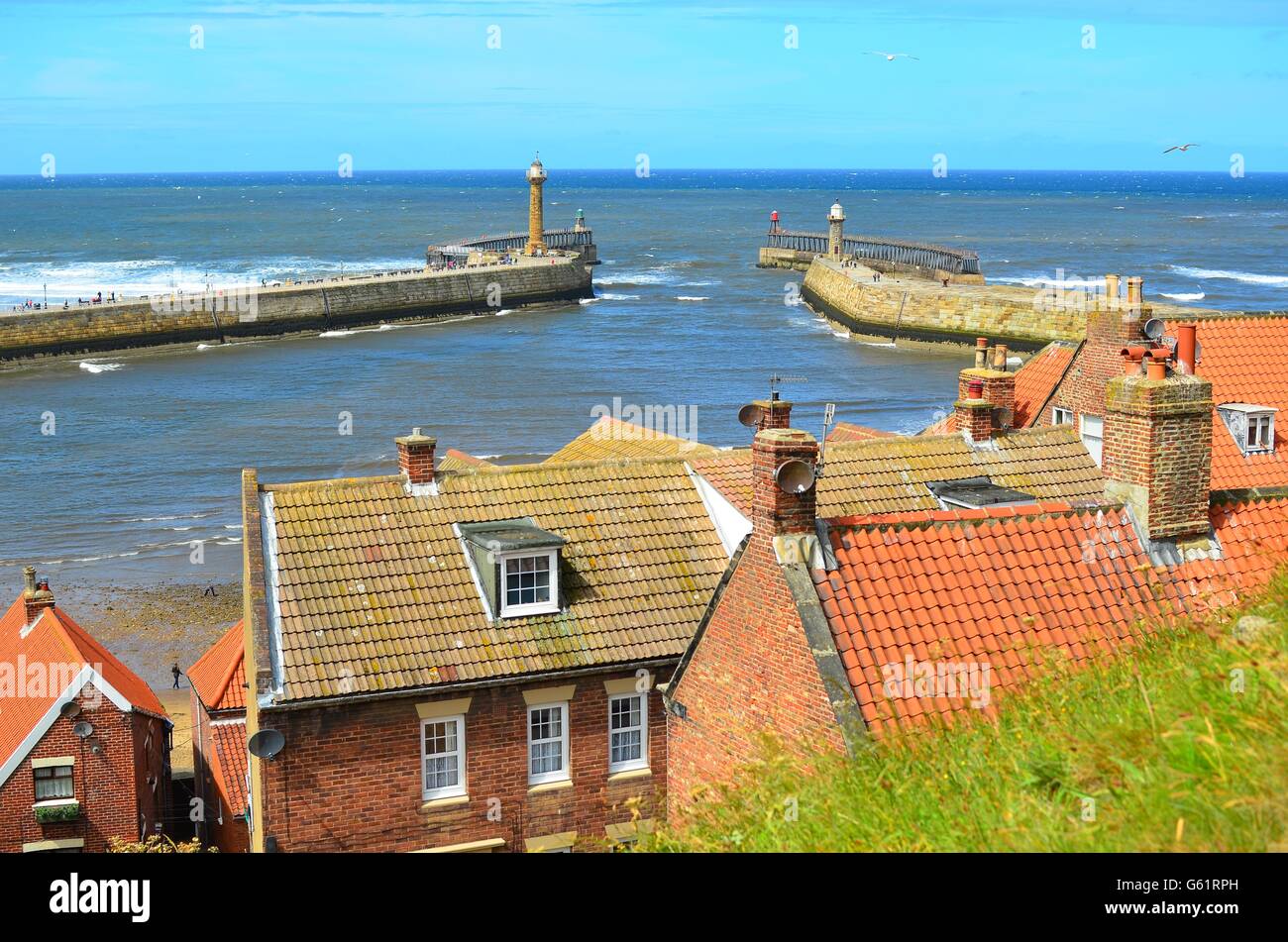 A view of Whitby Pier and harbour looking across rooftops in The North ...