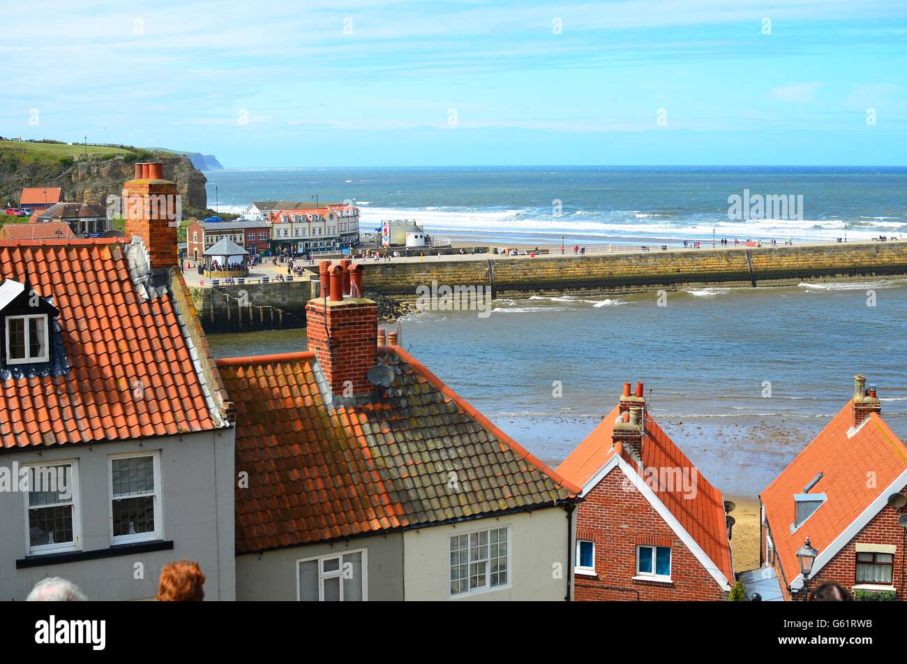 A view of Whitby Pier and harbour looking across rooftops in The North ...