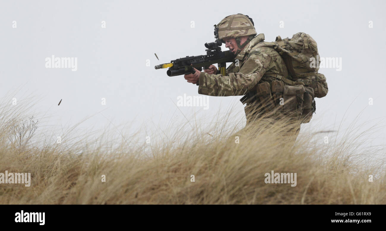 A member of 45 Commando Royal Marines fires his weapon ahead of ...