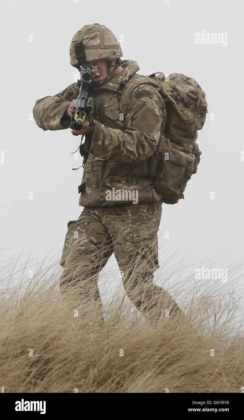 A member of 45 Commando Royal Marines looks down the sights of his ...