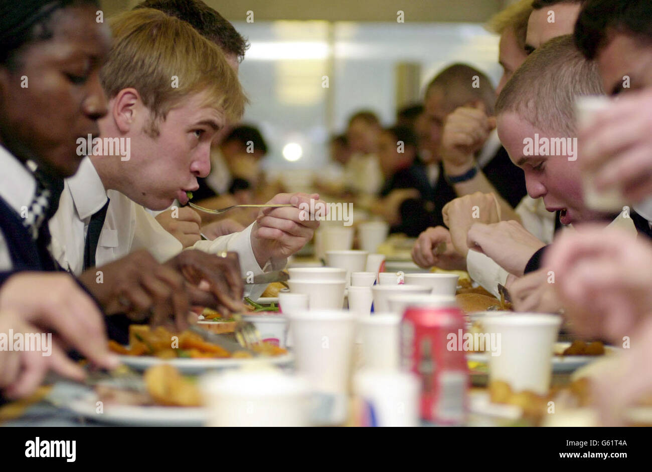 Police recruits tuck into their lunch in the canteen provided for them ...