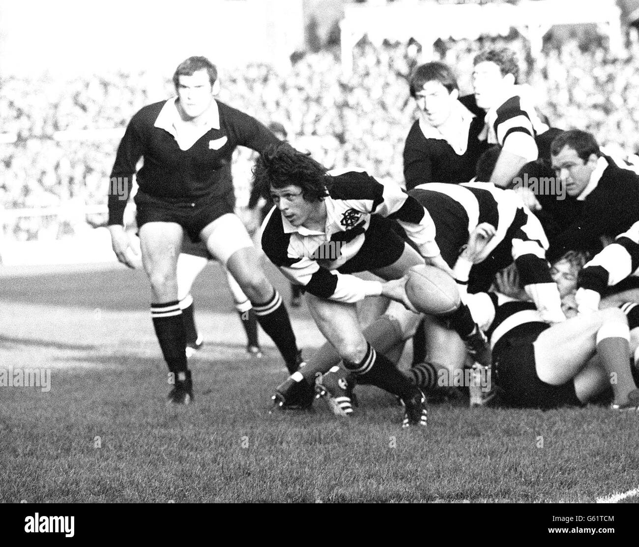 Barbarian scrum half Brynmor Williams passes the ball out from a loose ...