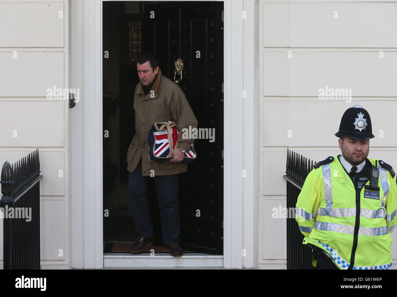 A man leaves the home of former Prime Minister Margaret Thatcher in ...