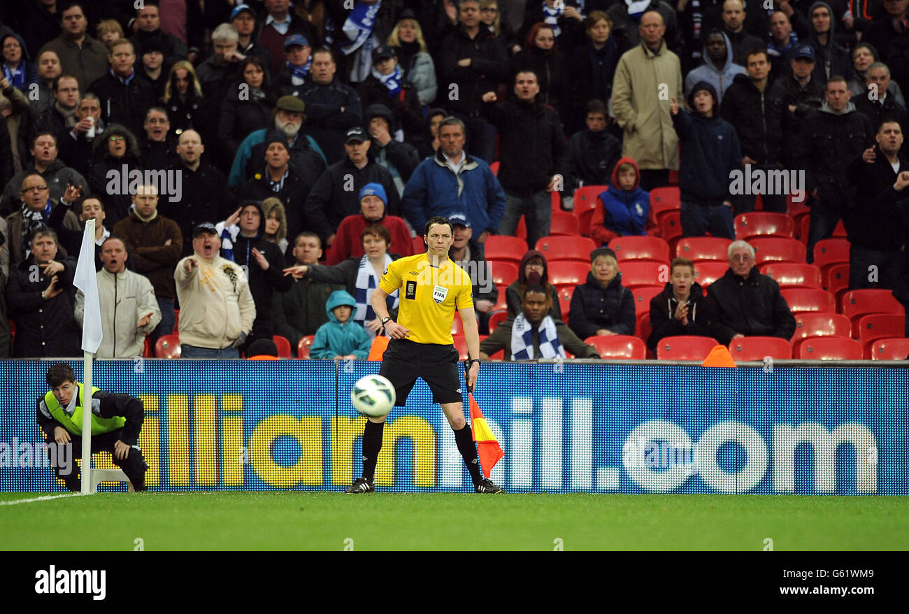 The assistant referee and the fans keep a close eye on the ball Stock ...
