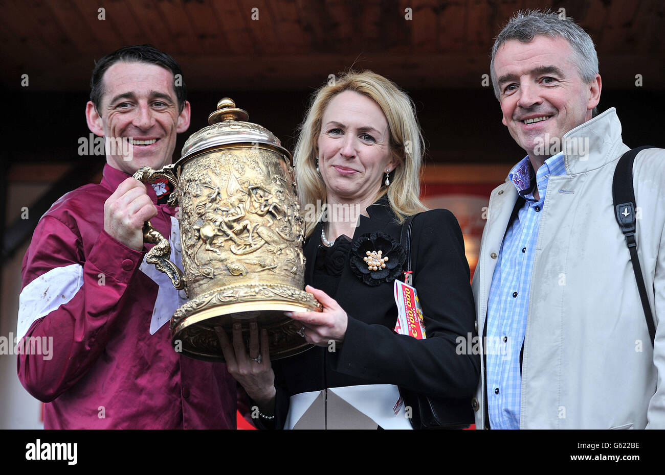 Jockey Davy Russell (left), owner Michael O'Leary (right) and his wife ...