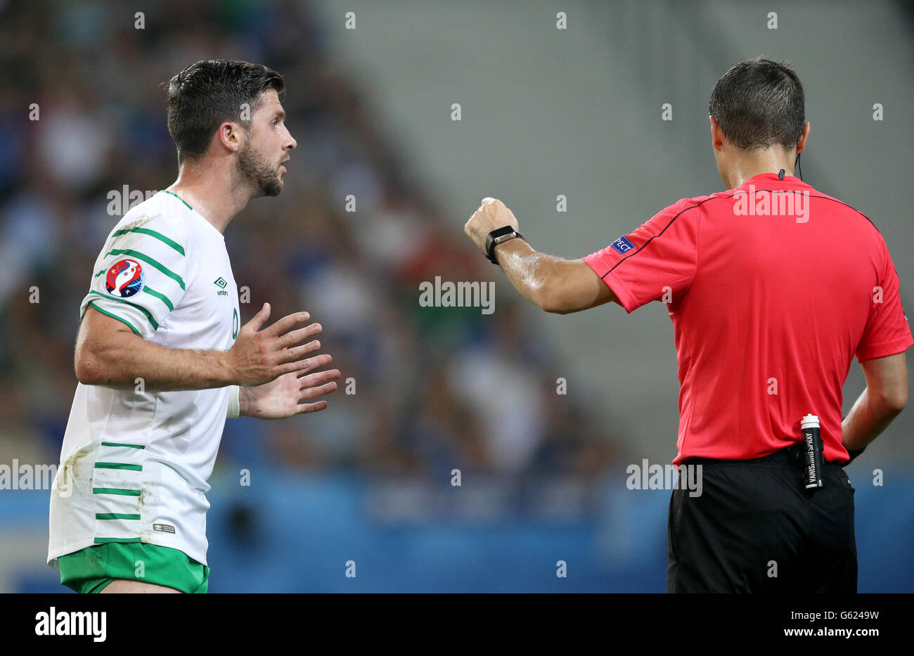 Republic of Ireland's Shane Long (left) argues with referee Ovidiu ...