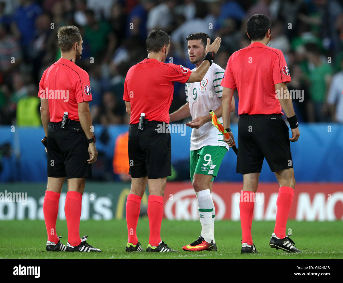 Republic of Ireland's Shane Long (centre) argues with referee Ovidiu ...