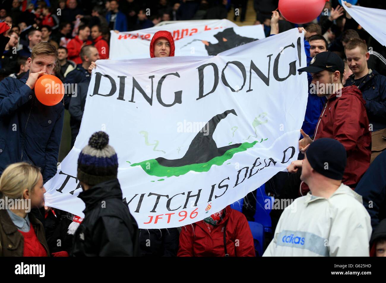 Liverpool fans hold up a banner about the death of Margaret Thatcher ...