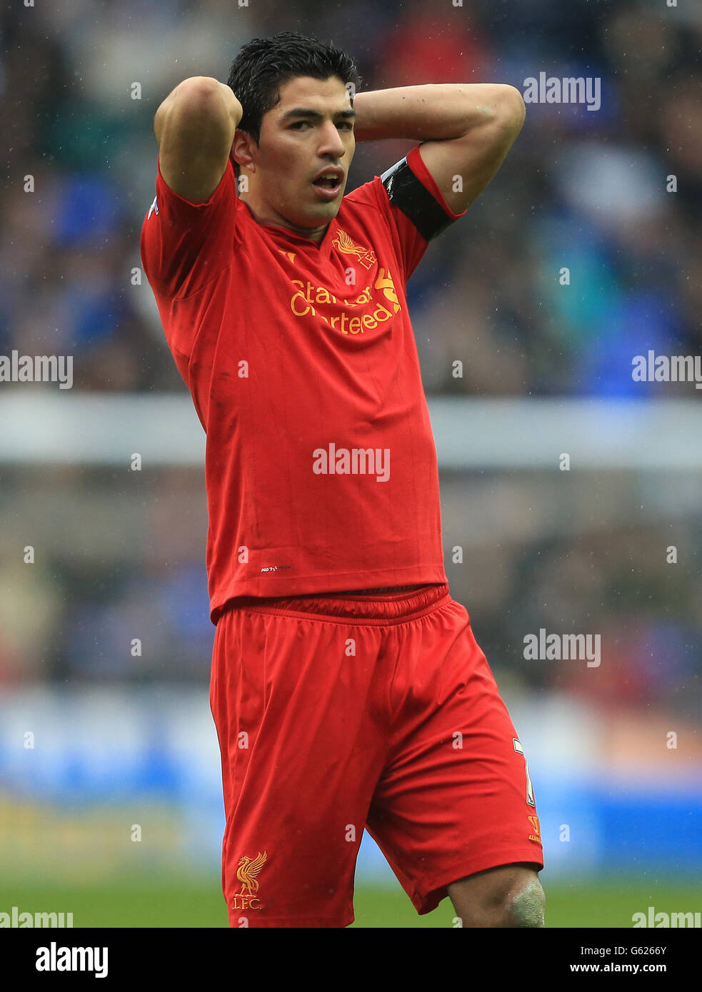 Liverpool's Luis Suarez holds his head in his hands after a missed ...