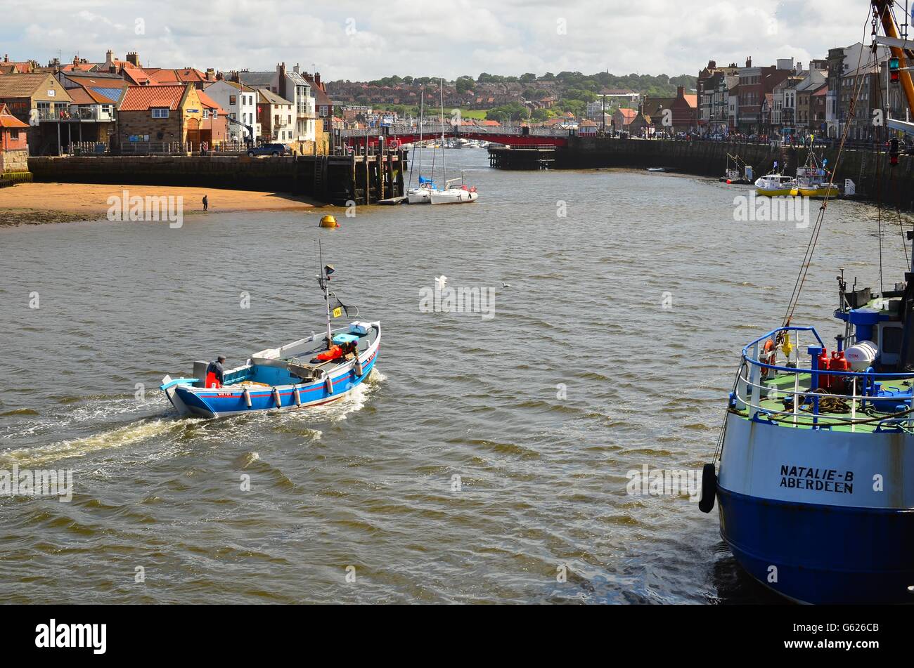 A boat entering Whitby harbour with the bridge in the distance Stock ...