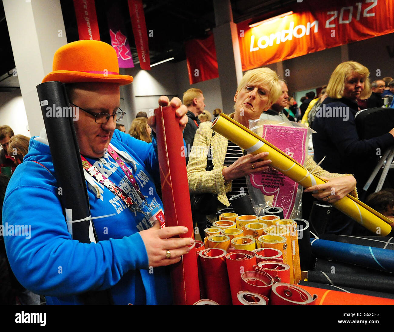 Members of the public attend the LOCOG sale of hundreds of items that ...