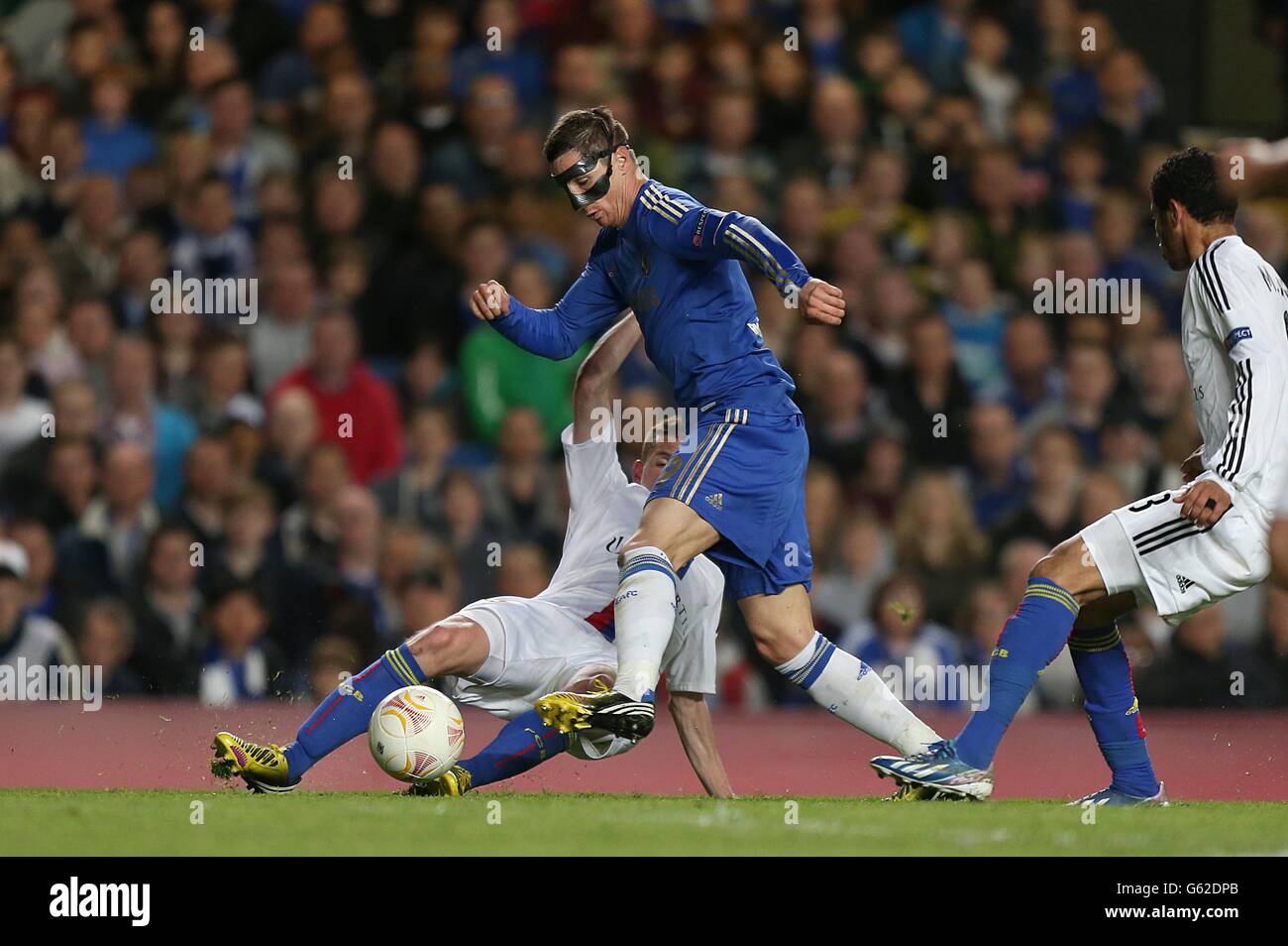 Chelsea's Fernando Torres (centre) goes down under a challenge from ...