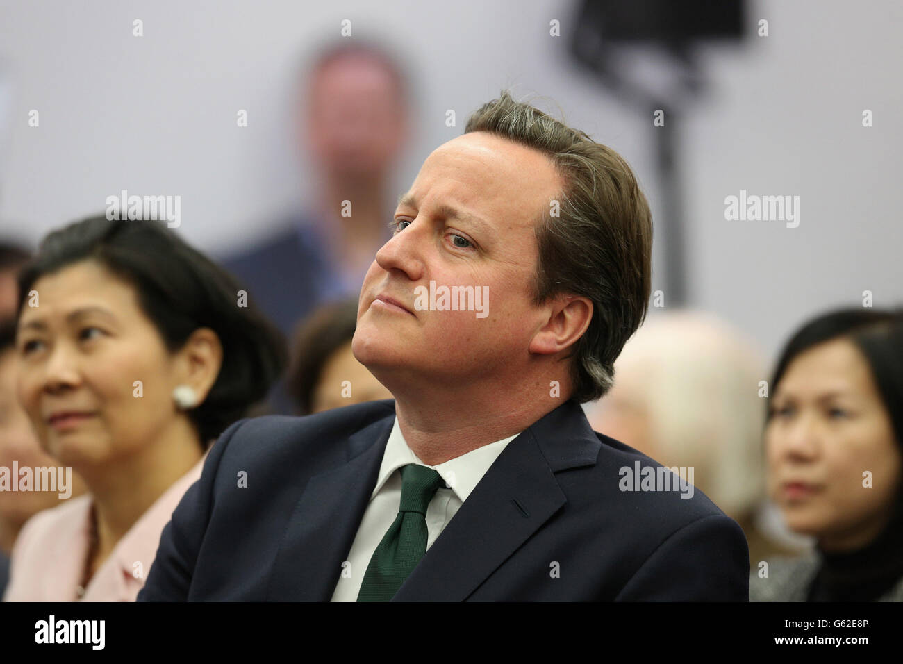 Prime Minister David Cameron (C) waits to address an audience in the ...