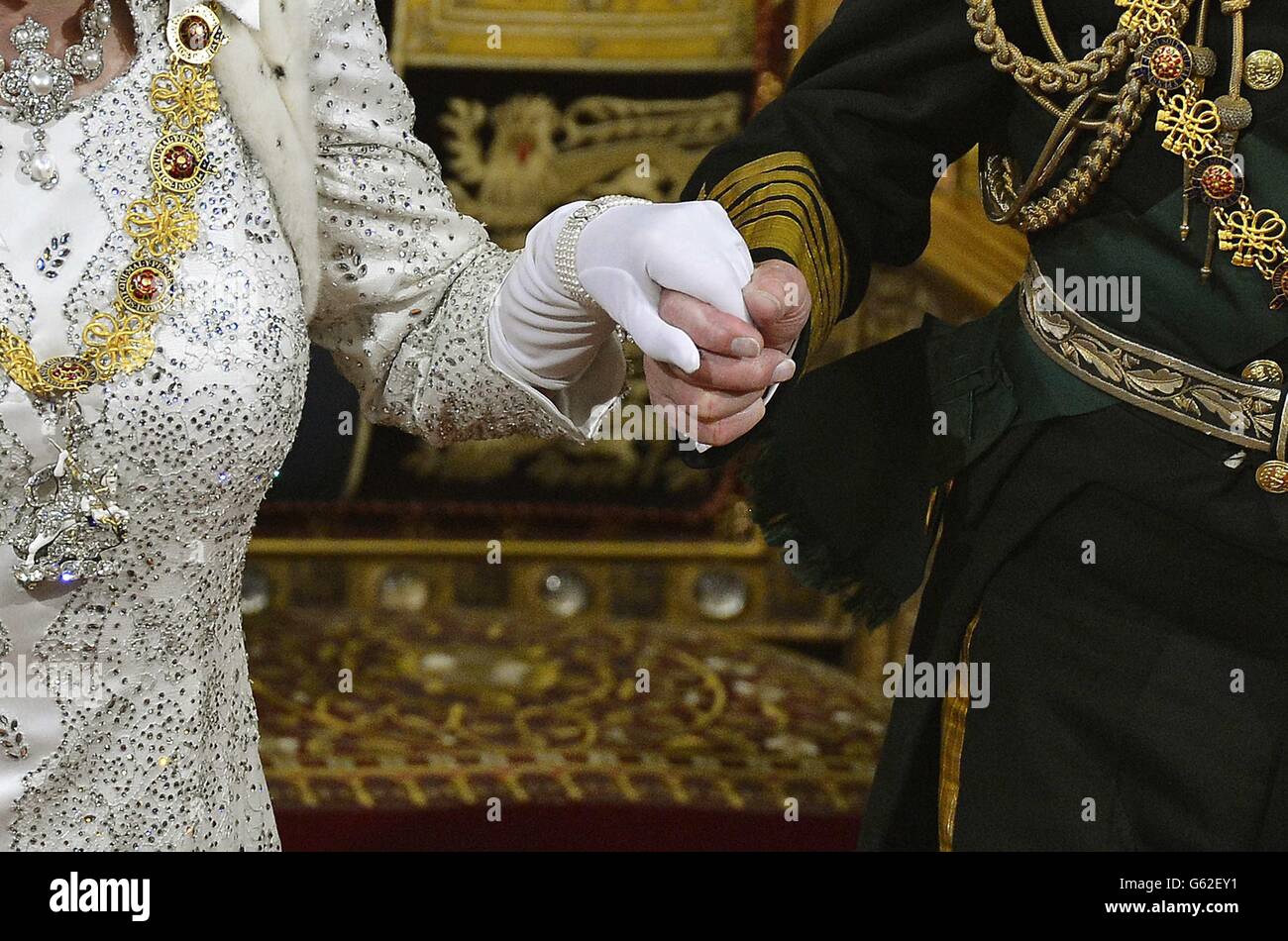 The Duke of Edinburgh takes the hand of Queen Elizabeth as they leave ...