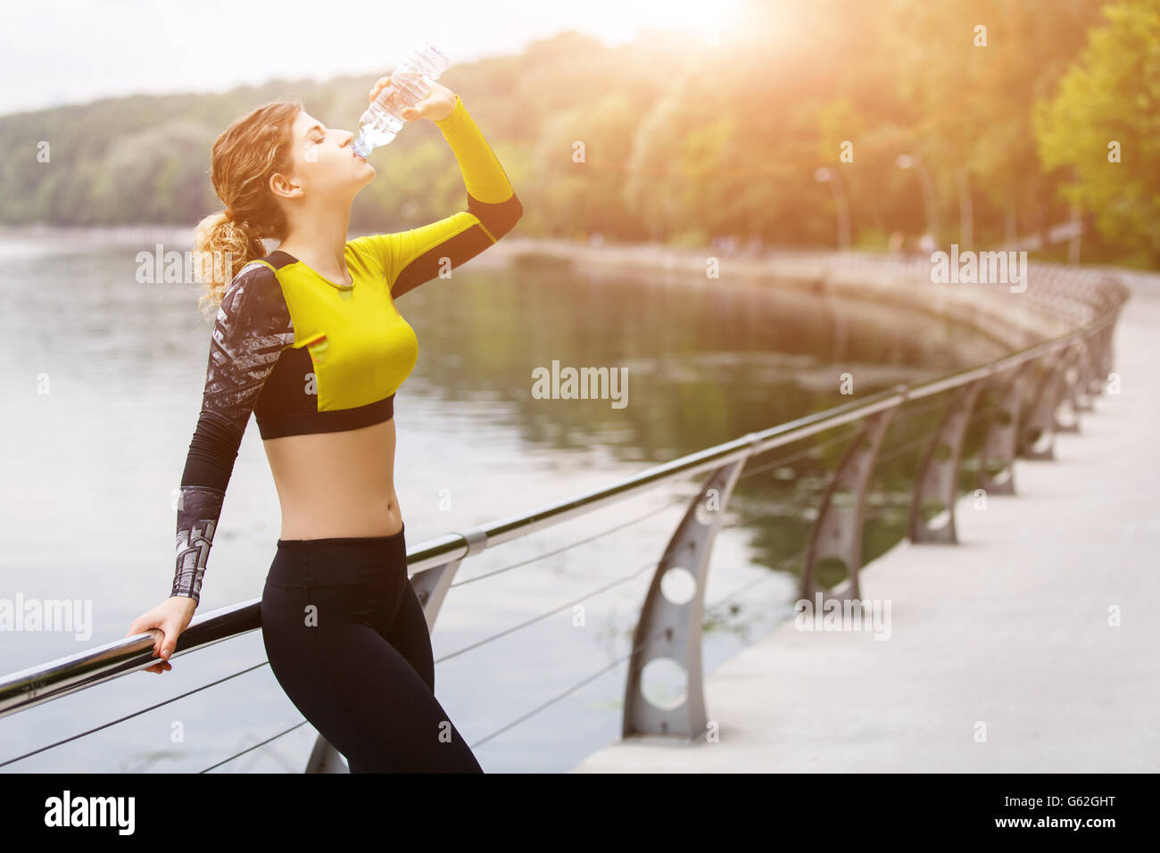 Athlete caucasian woman in sportswear drinking water after sport Stock ...