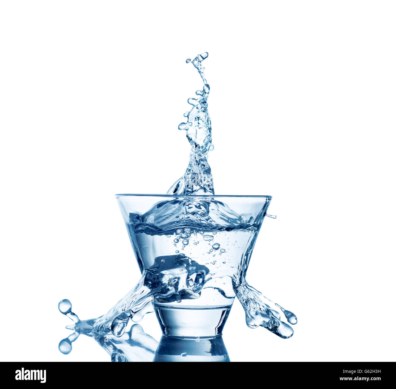 Ice cubes splashing into glass of water, isolated on white Stock Photo - Alamy