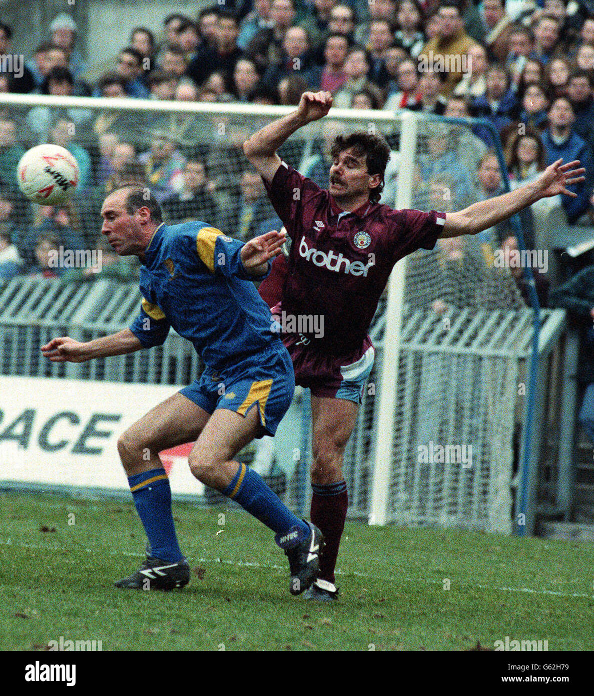 Wimbledon full-back Alan Cork (left) shields the ball from City full ...
