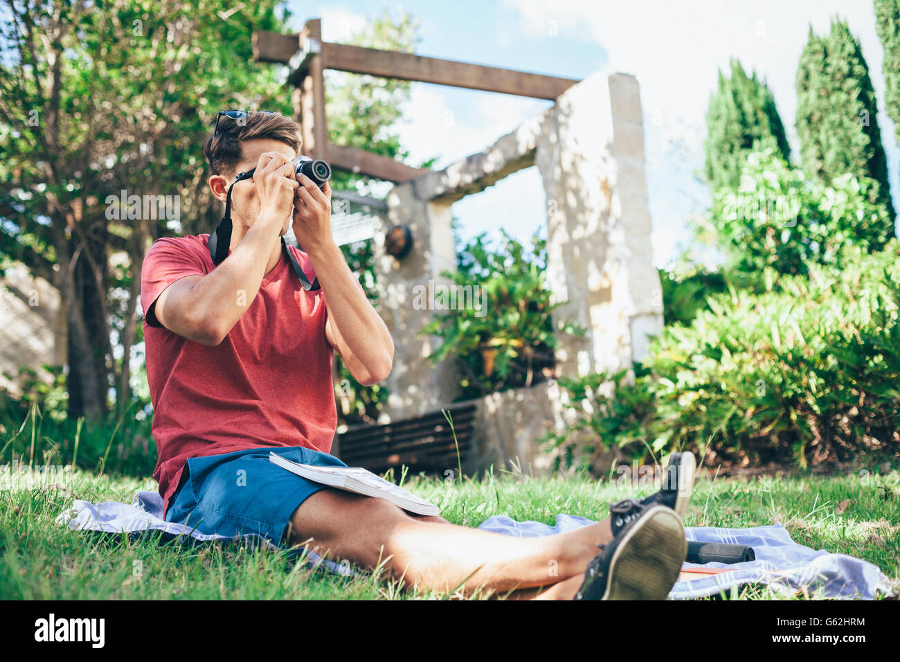 Handsome young man kicks back in his local park testing out his vintage ...