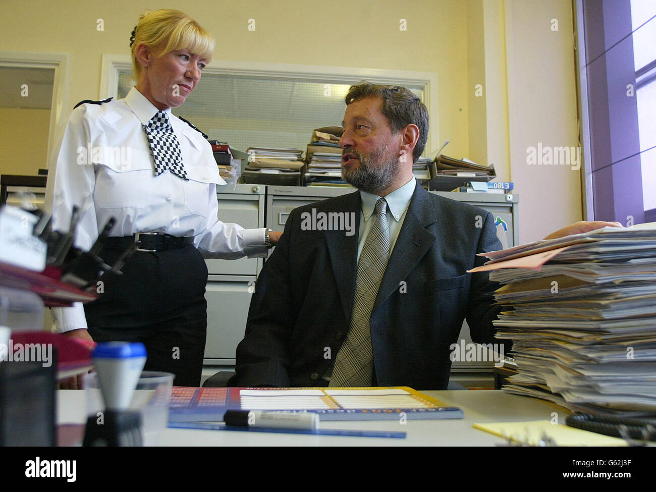 Home Secretary David Blunkett is shown a pile of police paperwork by ...