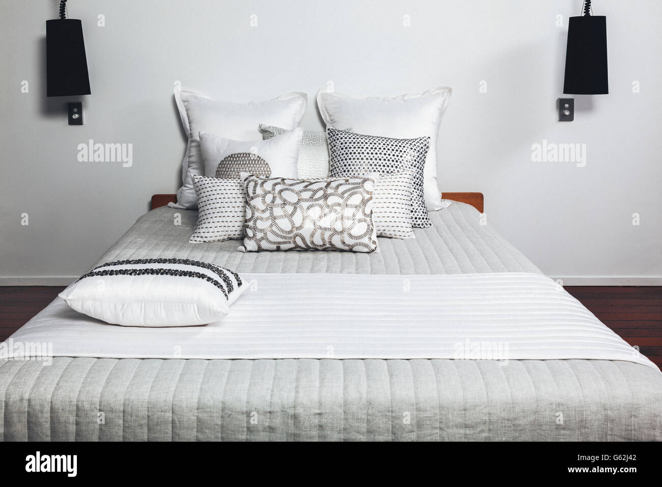 Styled bed in bedroom Stock Photo - Alamy