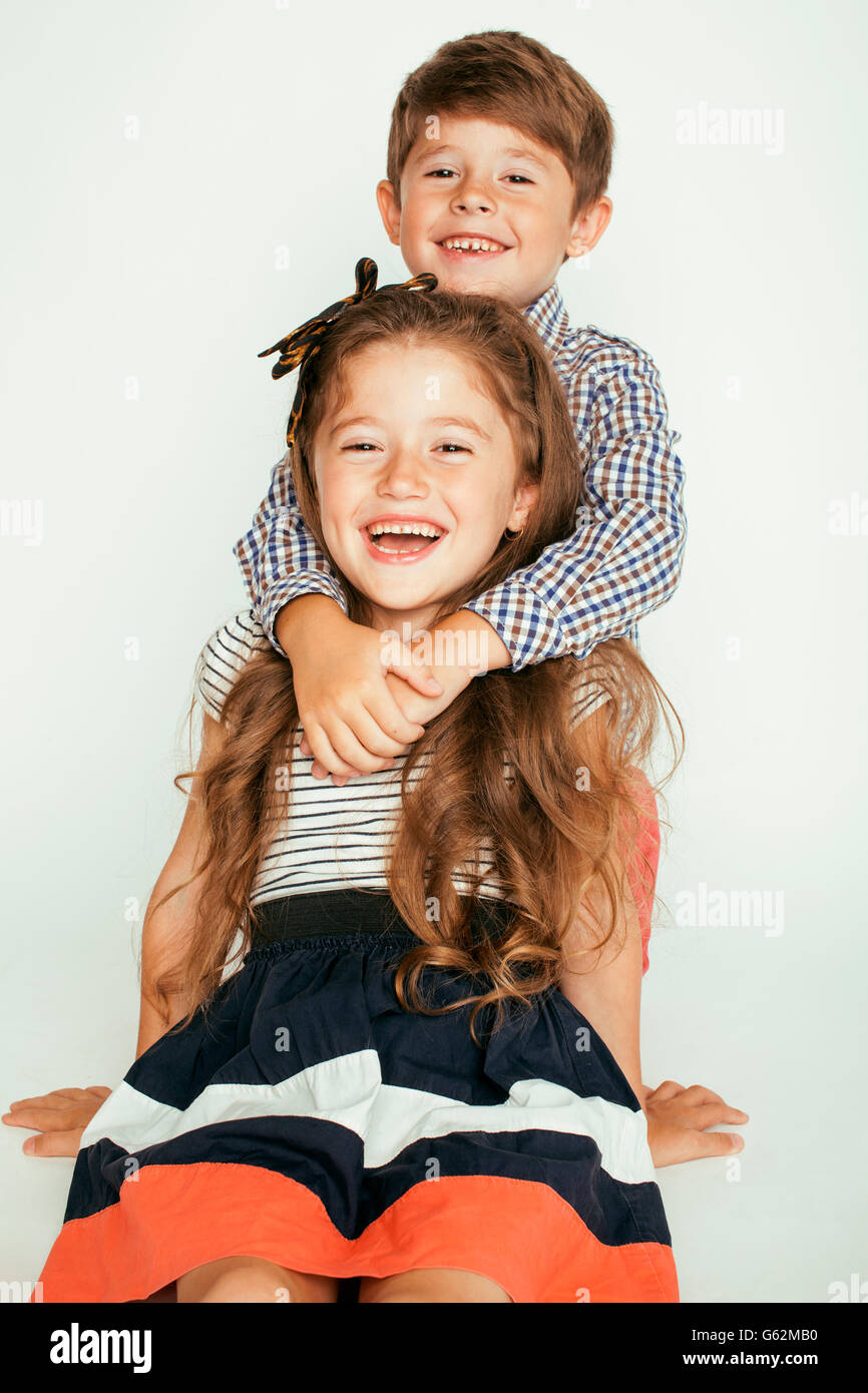 little cute boy and girl hugging playing on white background, happy family Stock Photo - Alamy