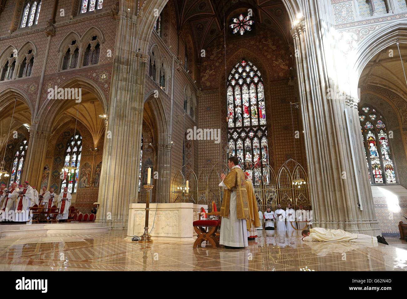 Monsignor Eamon Martin (right) lies on the floor during The Litany of ...
