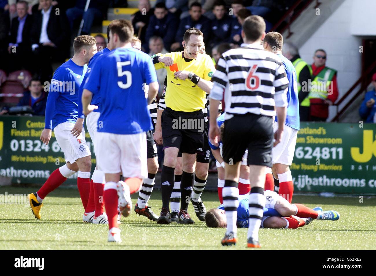 Referee Barry Cook puts away his red card after sending off East ...