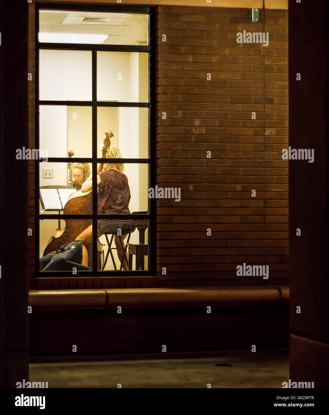 A woman practicing cello in the practice room Stock Photo - Alamy