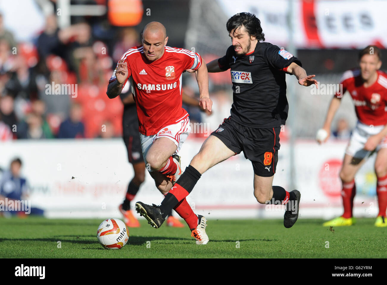 Swindon Town's Alan McCormack (left) and Brentford's Jonathan Douglas ...