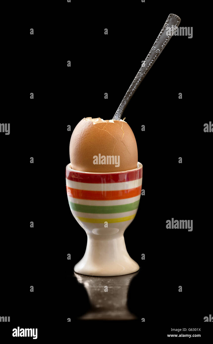 Boiled egg and spoon in the stand Stock Photo - Alamy