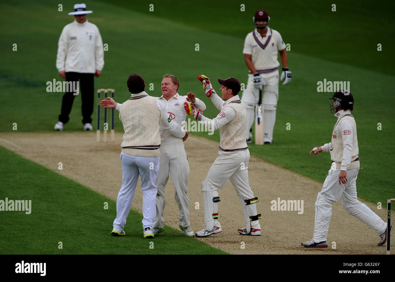 Surrey's Gareth Batty (centre facing) celebrates with Graeme Smith ...