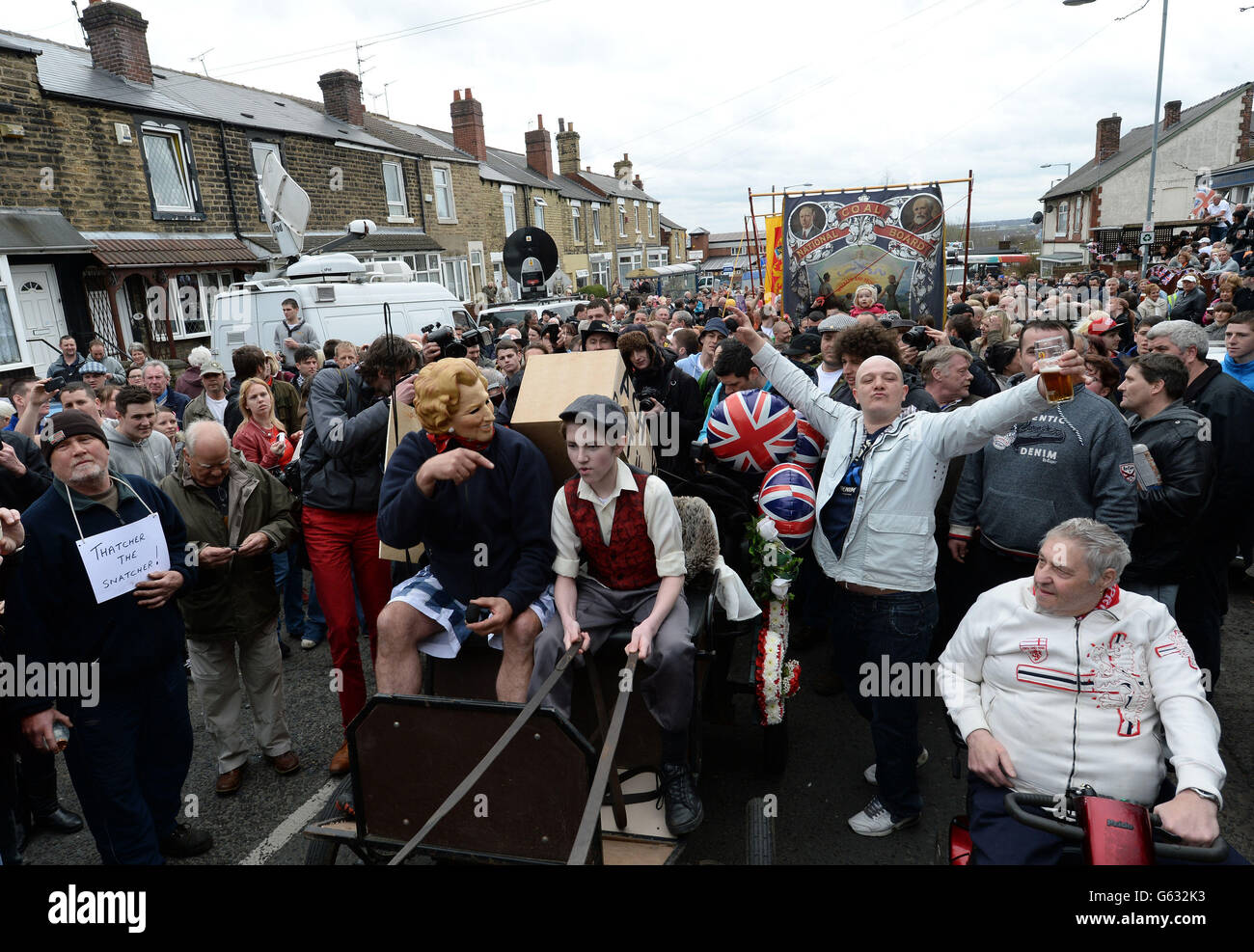 A horse drawn hearse carrying an effigy and a coffin pass Goldthorpe ...