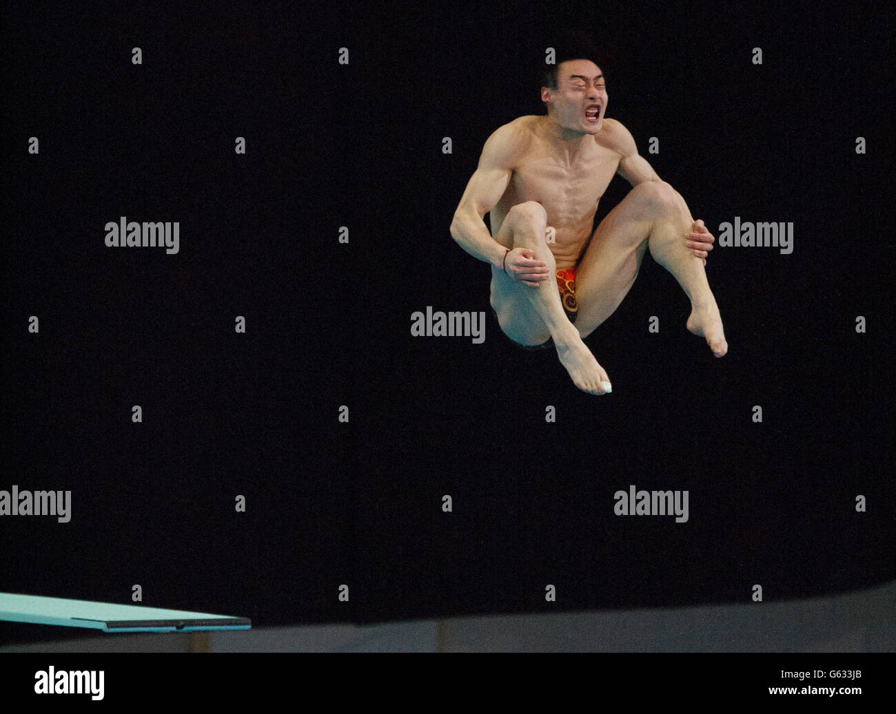 China's Chong He competes in the Men's 3m springboard event during the ...