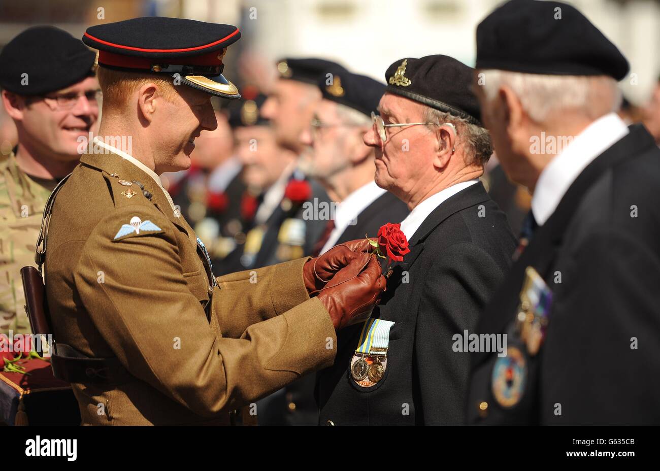 A red rose is pinned the the jacket of a Korean War veteran in St Peter ...