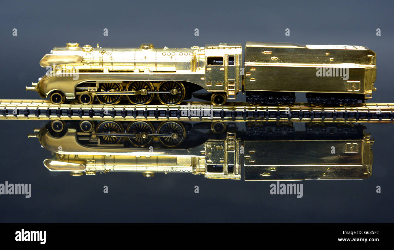 A solid gold 18 carat weight 3oz German class 10 steam Outline Locomotive and 8 wheel bogie ...