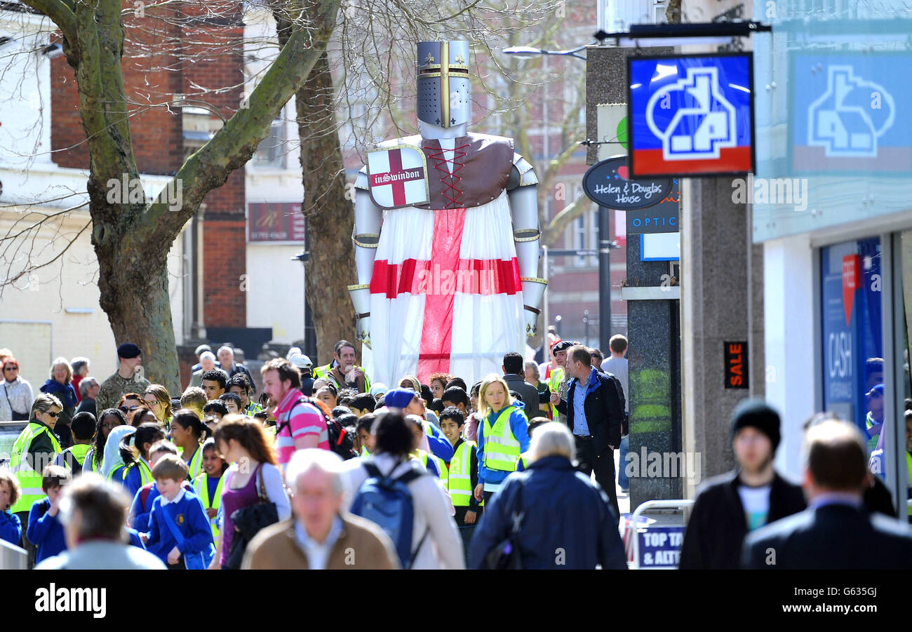 A 20ft high model of St George parades though Swindon Town centre for ...